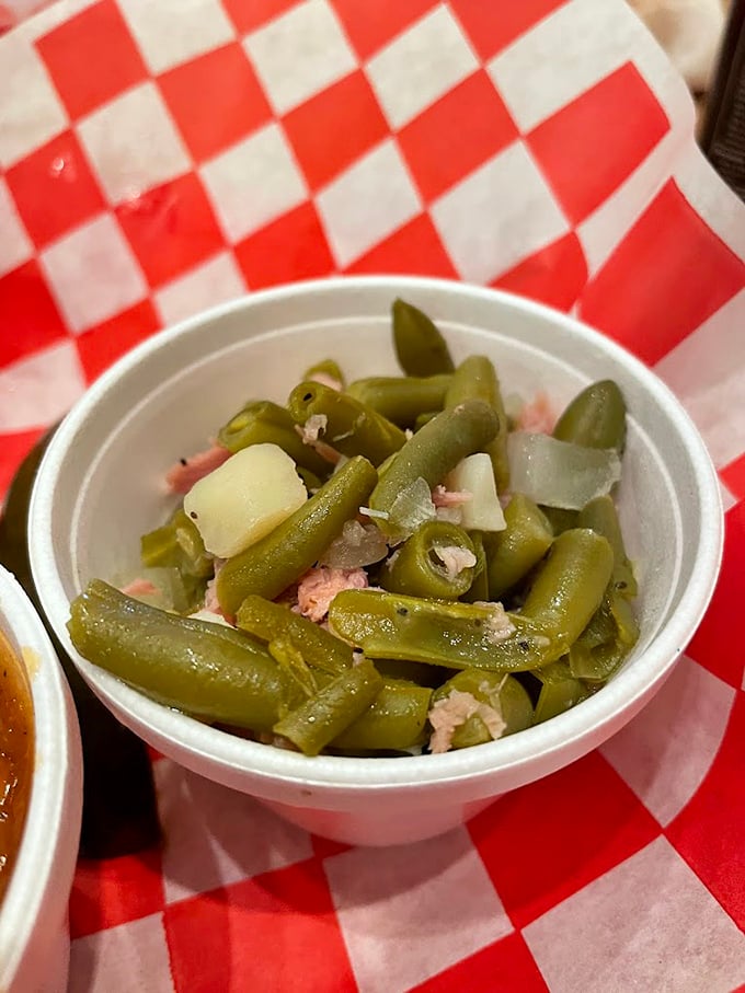 Green beans that have clearly been hanging out with pork. Not your grandmother's vegetable side—unless your grandmother was a pitmaster.