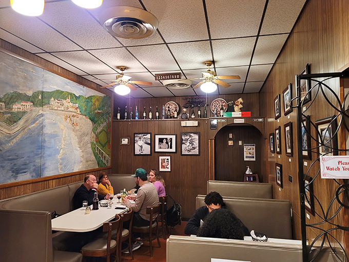 Wood paneling and Italian murals transport you straight to the old country. This isn't decoration—it's a time machine disguised as a dining room.