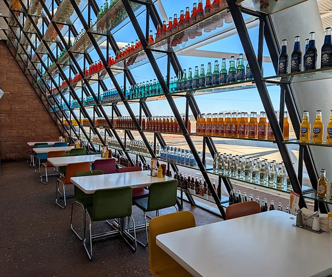 Dining among the bottles creates the curious sensation of eating inside a kaleidoscope, with sunlight filtering through colorful sodas like stained glass.