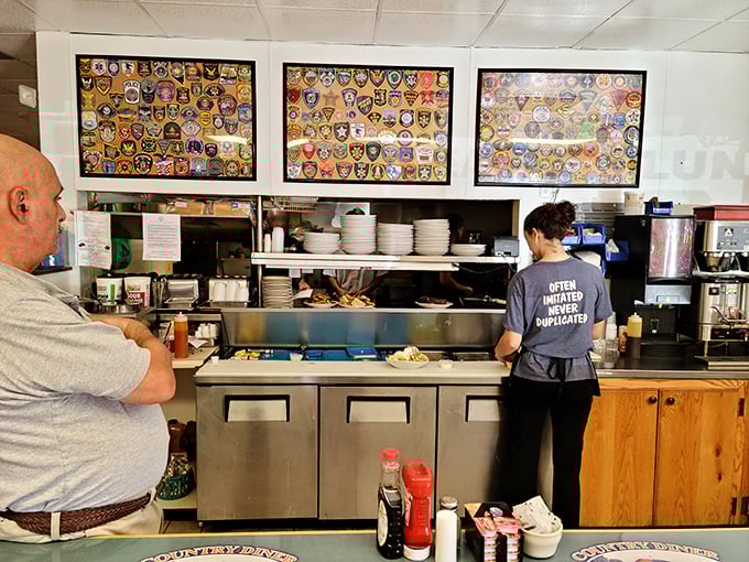 Where the magic happens—the open kitchen design lets you watch breakfast artists at work. Those patch displays add character you can't manufacture.