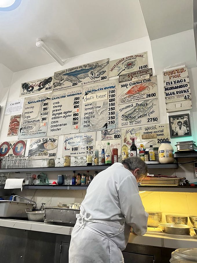 Where the seafood sorcery happens – white-aproned wizards transforming the ocean's bounty into memorable meals with practiced precision.