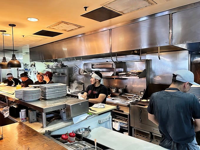 The open kitchen reveals the choreographed chaos behind culinary magic—chefs as performers in the tastiest show in town.