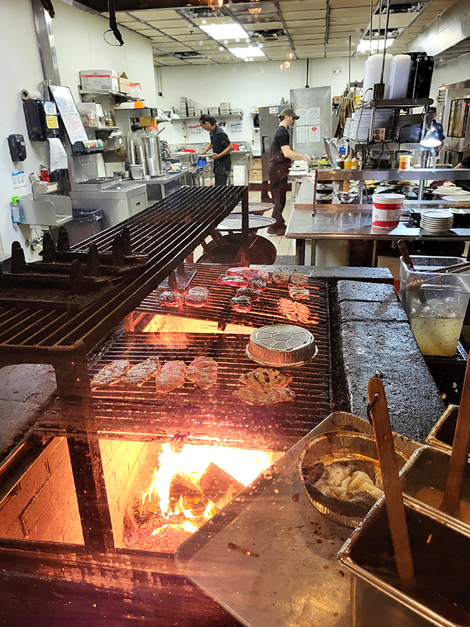 The open kitchen with its massive grill lets you watch your steak being cooked over real flames—dinner and a show.