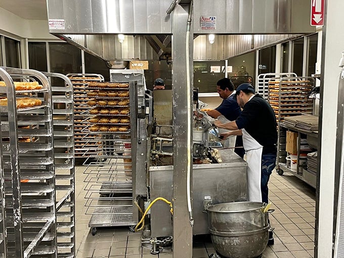 Racks upon racks of freshly made donuts await their moment of glory. This is what dreams are made of—specifically, my dreams.
