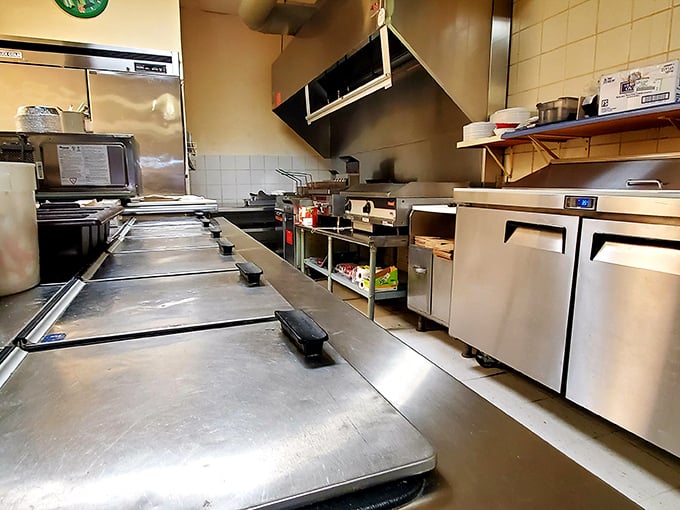 The kitchen—hallowed ground where pizza magic happens. Those stainless steel counters have seen more dough transformations than a lottery winner's life.
