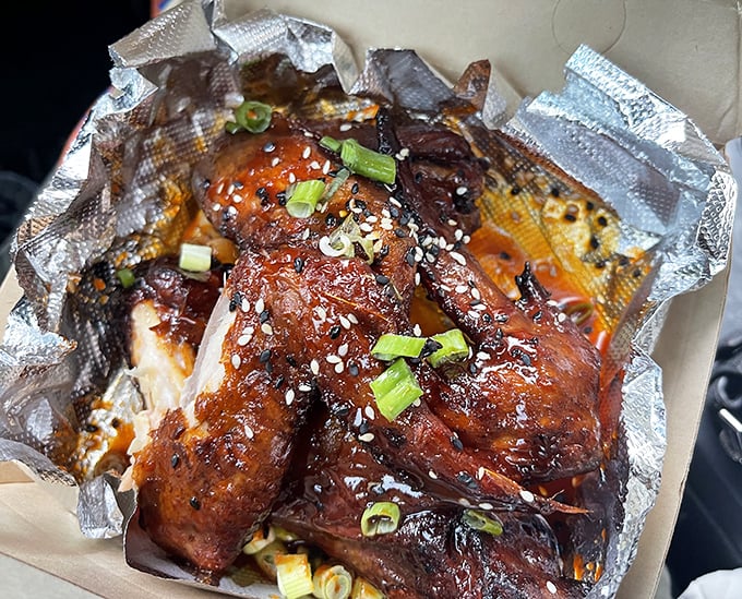 Korean-style wings glistening with sweet-spicy glaze and green onions – proof that barbecue transcends borders and speaks a universal language.