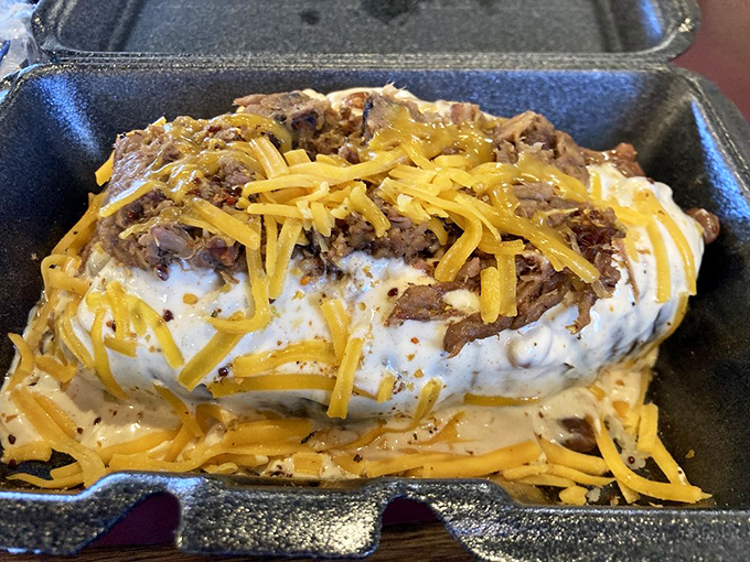 A loaded baked potato that's dressed more impressively than most people at a Kansas wedding. Cheese, meat, and pure joy. 