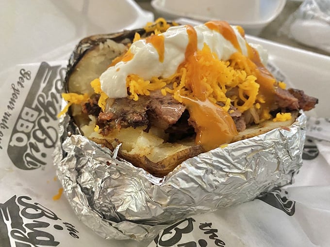 This loaded potato isn't just food—it's architecture. A foundation of spud supporting the structural integrity of meat, cheese, and sour cream with engineering precision.