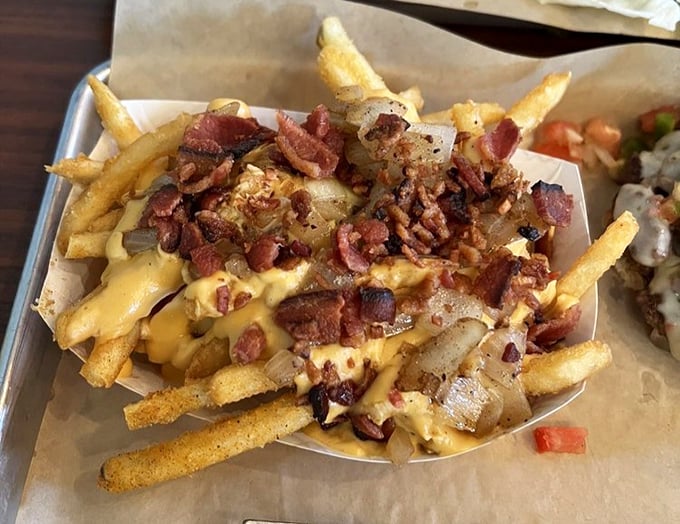 These aren't just cheese fries—they're a masterpiece of melted goodness, crispy potatoes, and bacon that would make Michelangelo weep.