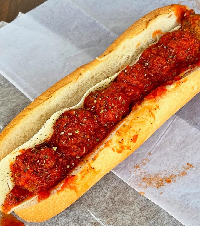 The meatball sub – where perfectly seasoned spheres of meat meet marinara in a hot, saucy romance that's worth every napkin.