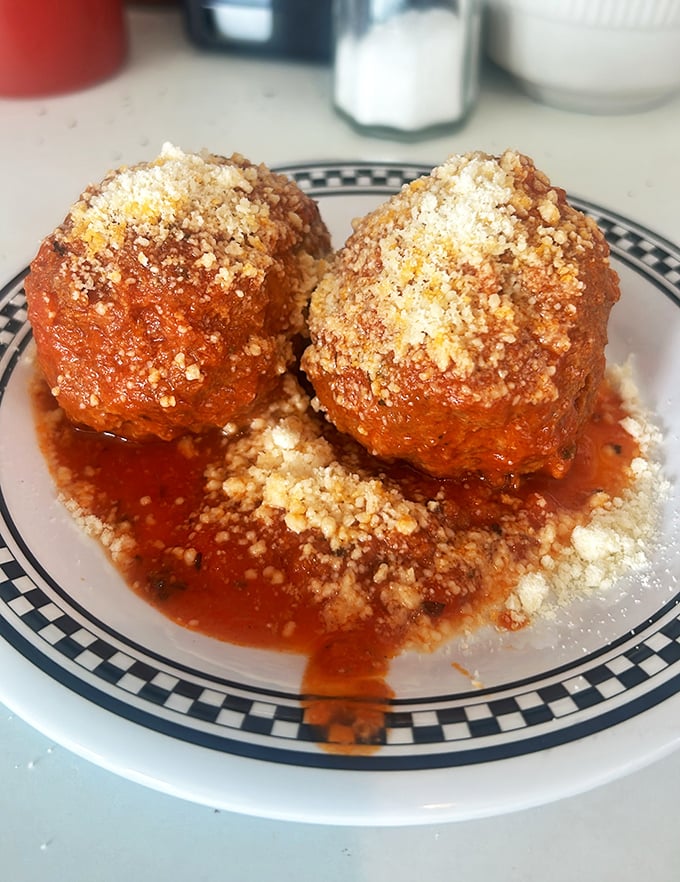 These meatballs aren't trying to be Italian masterpieces—they're honest, hearty Midwestern comfort swimming in rich tomato sauce.