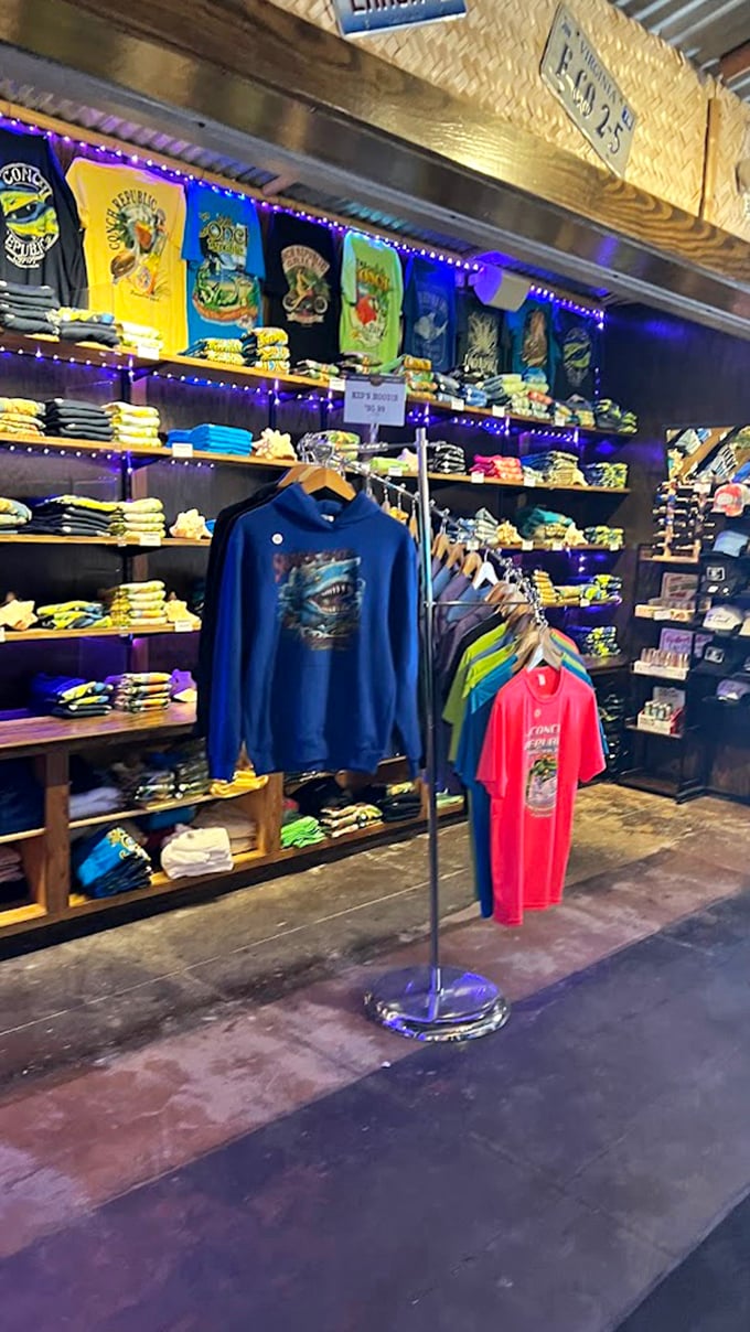 The merch wall proves you're not just at a restaurant but a lifestyle destination. Nothing says "I survived vacation" like a shark-emblazoned hoodie.