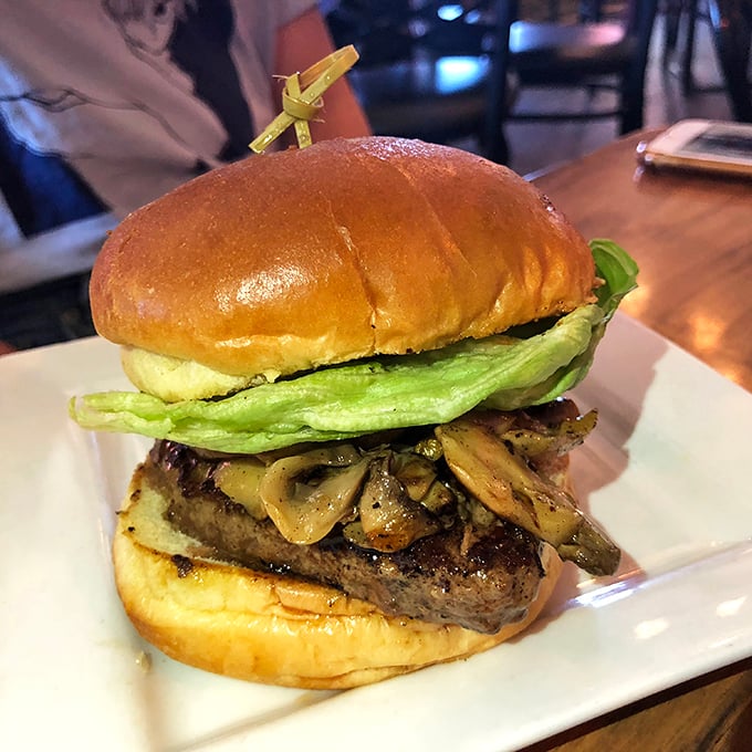 This isn't just a burger; it's architecture. Layers of beef, mushrooms, and fresh lettuce create a skyscraper of flavor worth climbing.