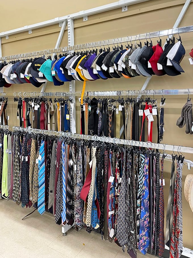 Neckties and baseball caps sharing space like a business casual meeting crashed by weekend warriors seeking discounted team spirit.