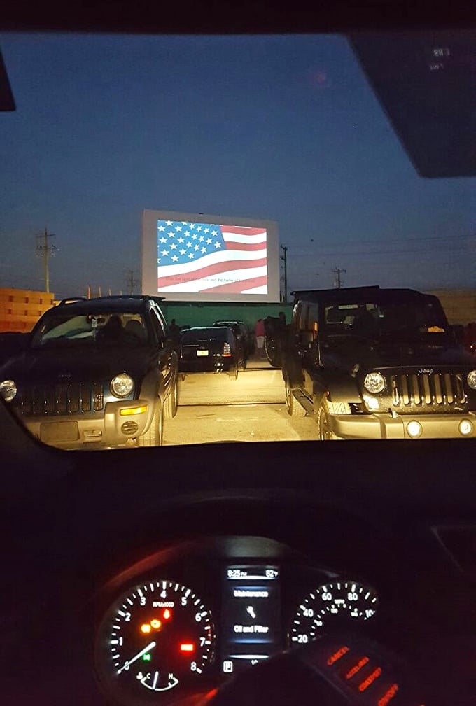 The American flag greets moviegoers—watching films under the stars feels patriotic somehow, a celebration of simple pleasures.