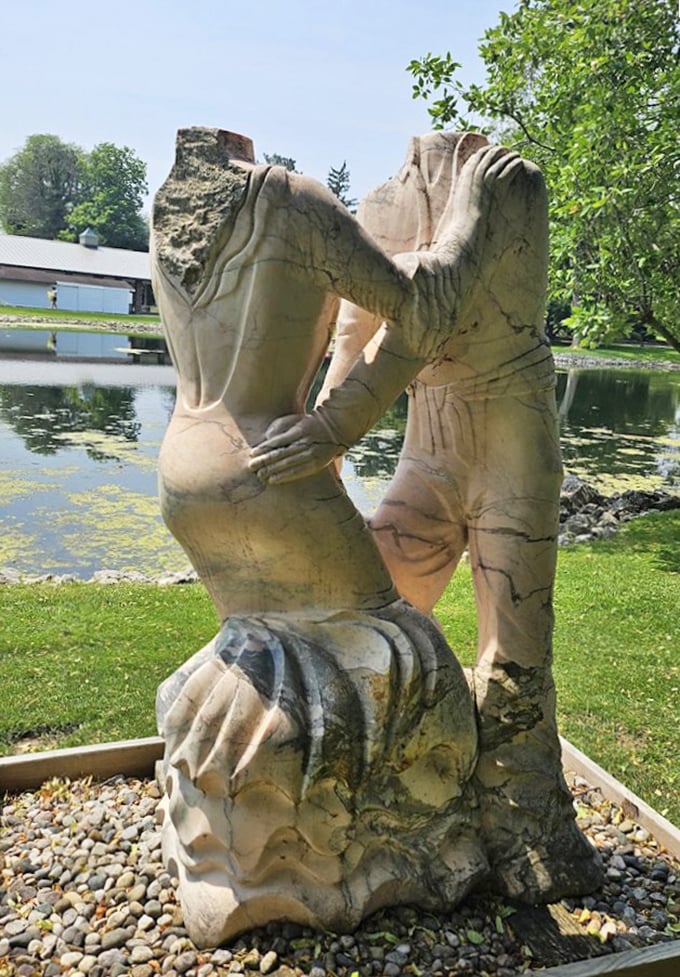 Love set in stone. This abstract sculpture captures the essence of connection—proving that even in a garden full of beauty, human bonds remain most captivating.