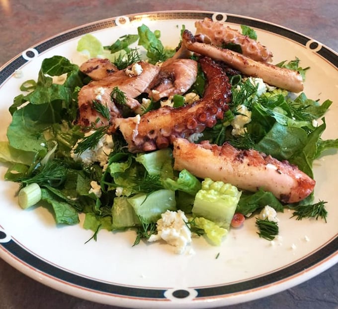 This octopus salad proves diners aren't just about burgers and fries. Tender tentacles nestled among greens—Mediterranean influence swimming right into Queens.