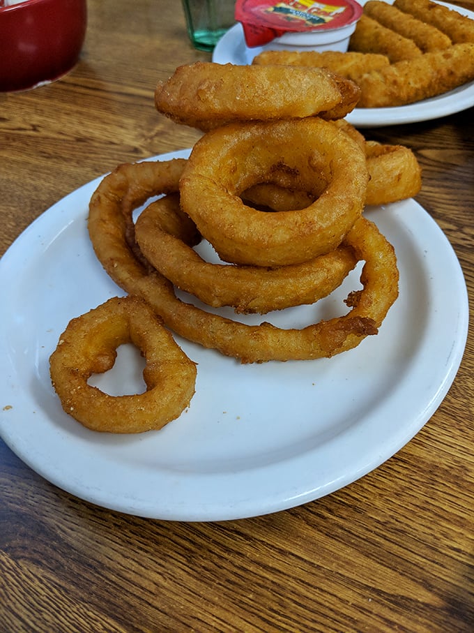 Onion rings with the structural integrity of Olympic gold—crispy, substantial, and demanding to be the main event rather than a side dish.