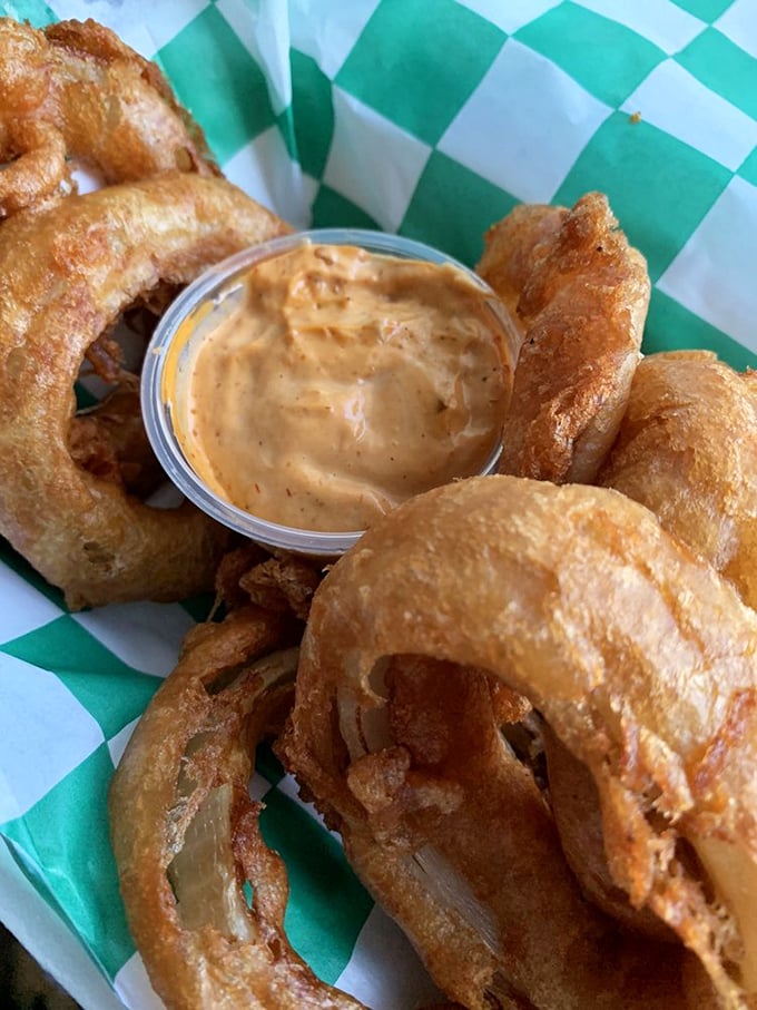 The legendary onion rings—golden halos of perfection with a dipping sauce that deserves its own fan club. Worth crossing state lines for.