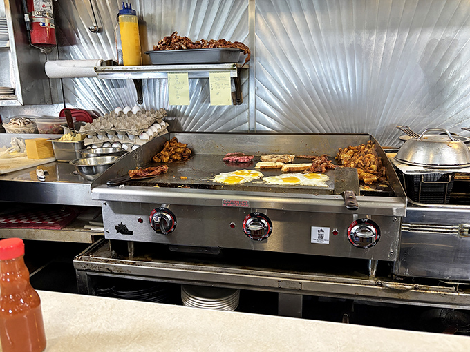 Behind the counter magic happens—eggs sizzle, bacon crisps, and home fries transform from humble potatoes into breakfast royalty.