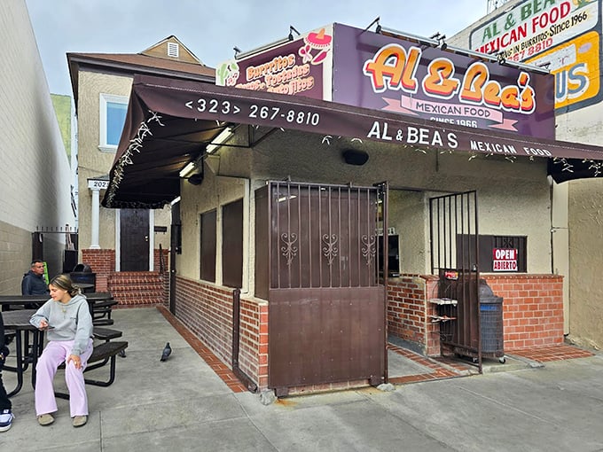 The outdoor seating area offers a front-row view to Boyle Heights life—a perfect stage for the main event happening inside your takeout container.