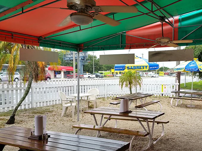 The covered outdoor area—where ceiling fans battle Florida heat while you battle hunger. The red and green ceiling adds a touch of year-round Christmas spirit.
