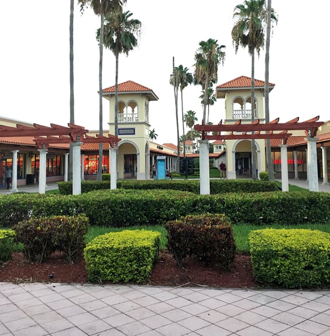 Manicured gardens and pergolas create peaceful walkways between shopping adventures—a retail oasis that feels more resort than mall.