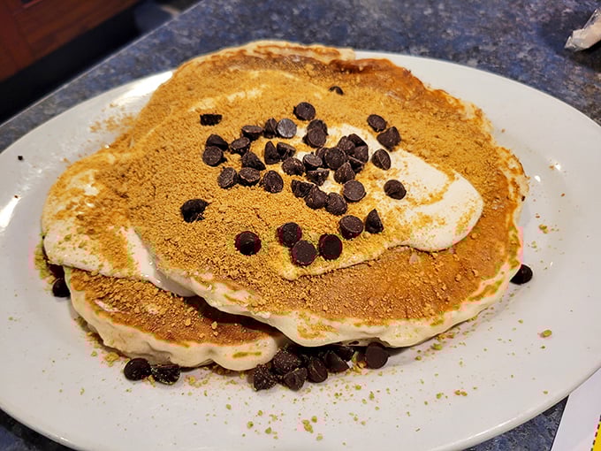 These aren't just pancakes—they're edible pillows dusted with cinnamon and chocolate chips, ready to soak up maple syrup like they've been waiting their whole lives for this moment.
