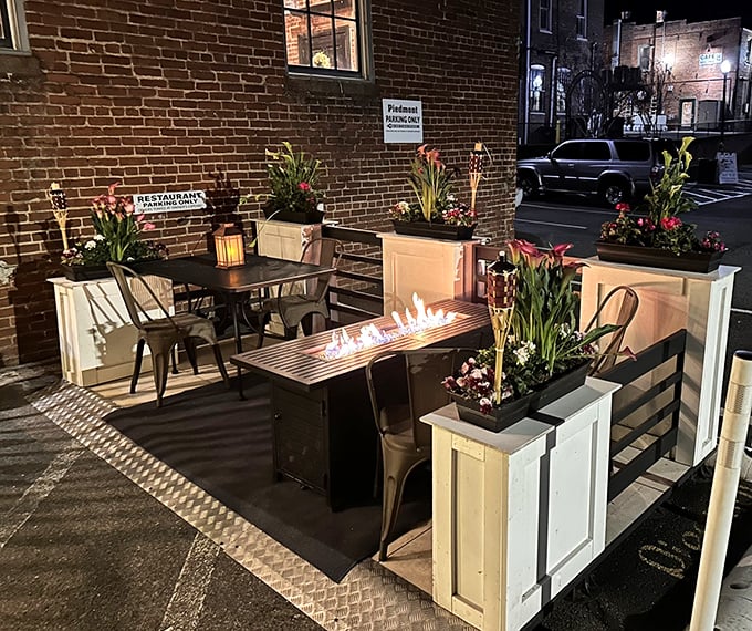 The outdoor patio brings fire and flora together—a nighttime sanctuary where cocktails taste better under stars and between blooming planters.