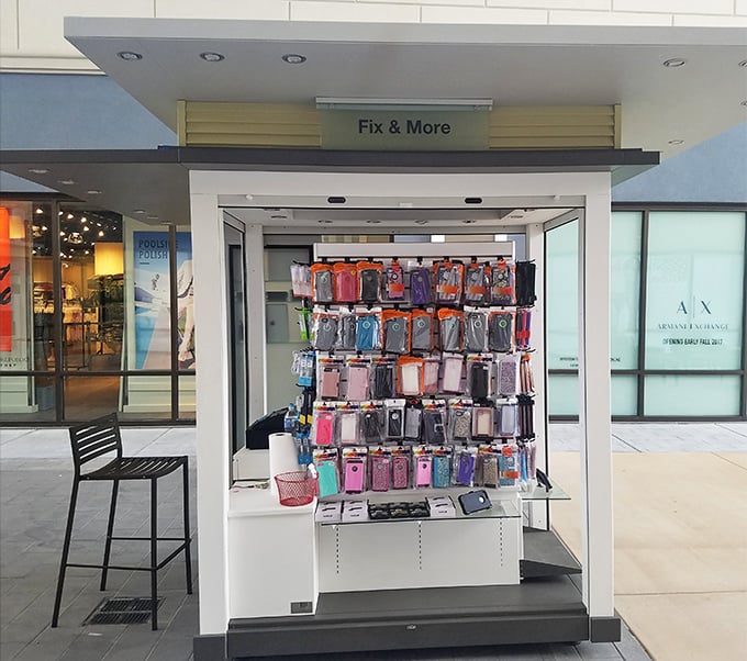 This phone case kiosk stands ready to protect your most precious shopping companion – the device you'll use to brag about your deals.