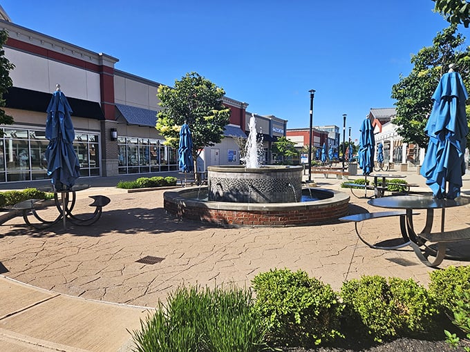 This fountain courtyard isn't just pretty—it's a tactical rest stop where shopping strategies are recalibrated and second winds are caught. Those blue umbrellas offer shade for the serious planners.