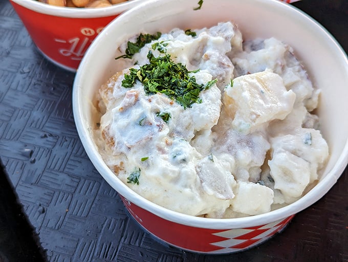 Creamy potato salad that doesn't just complement the chicken—it rescues your taste buds when you've overestimated your spice tolerance.