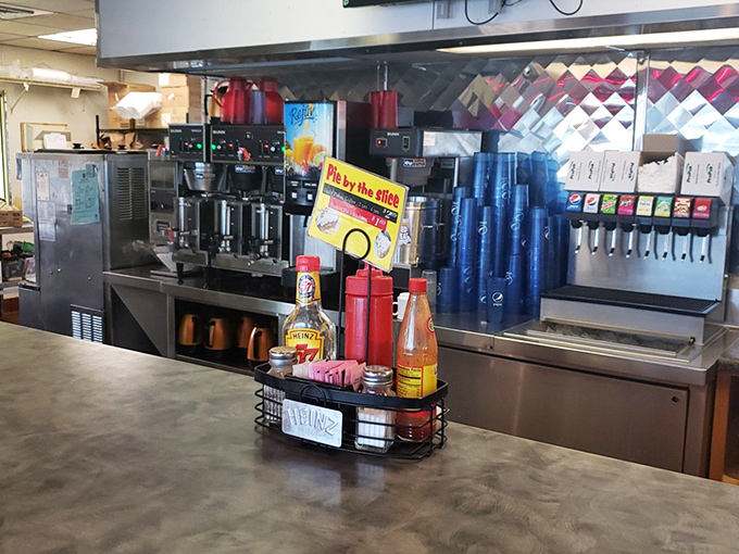 The beating heart of any proper diner – where condiments stand ready for duty and coffee flows like a caffeinated river of dreams.