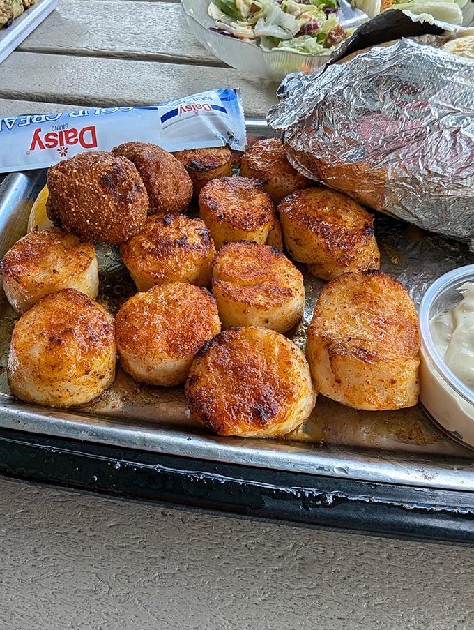 These scallops aren't just seared—they're transformed into caramelized medallions of oceanic perfection, ready for their close-up.