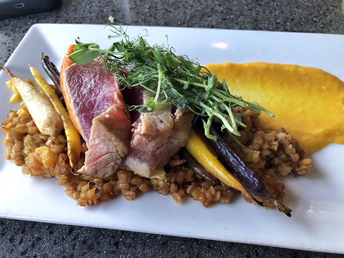 Tuna seared just enough to be polite, resting on a bed of grains that have clearly been invited to the right party.