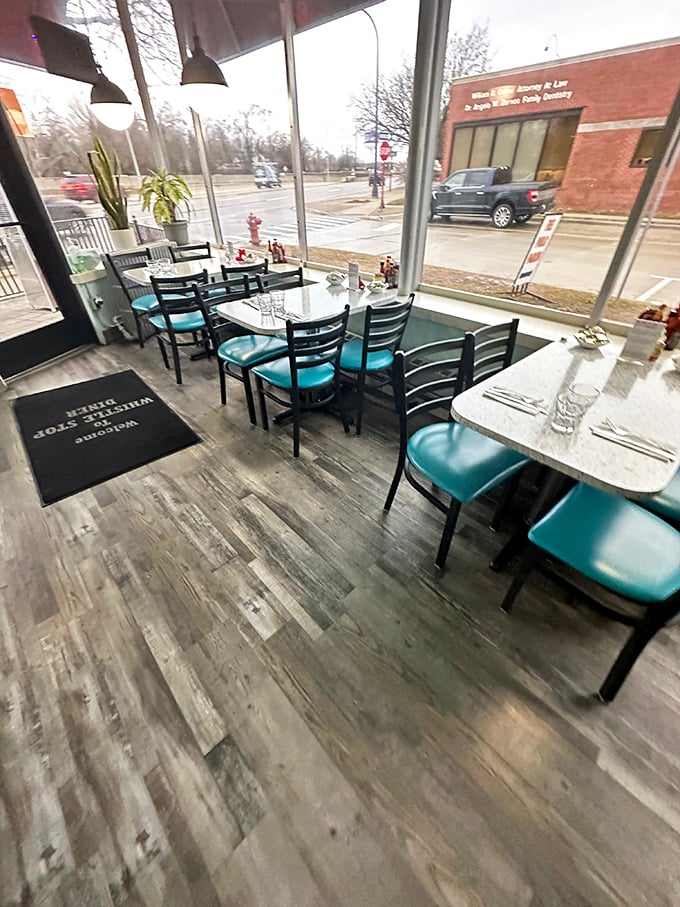 The dining area isn't just filled with tables—it's lined with front-row seats to Woodward Avenue's daily parade, all bathed in Michigan's mercurial natural light.