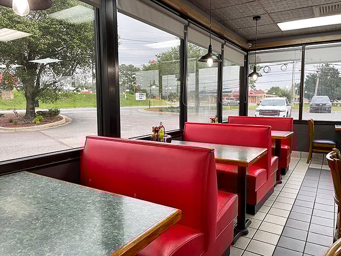 Window booths bathed in natural light – where red vinyl seating has cradled countless conversations and comfort food moments through the years.