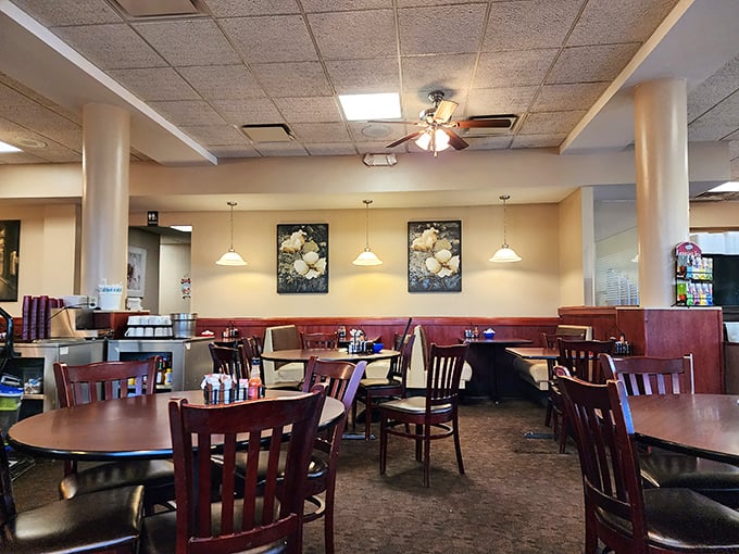 Classic diner geometry: pendant lights hanging like stars above wooden chairs and tables arranged for maximum breakfast enjoyment.
