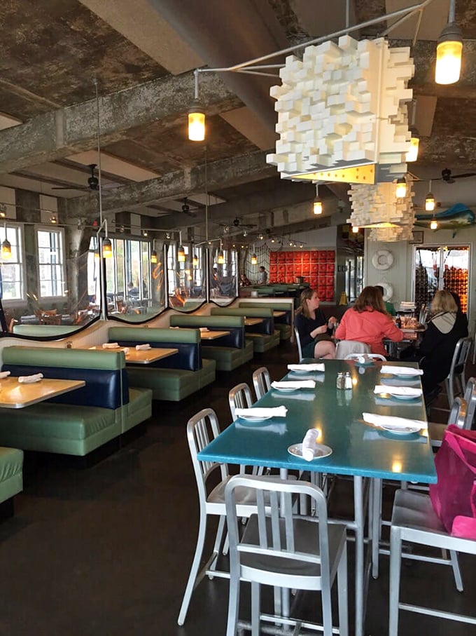 Navy blue booths and turquoise tables create a maritime color palette that says, "Yes, you're definitely dining waterside in Charleston now."