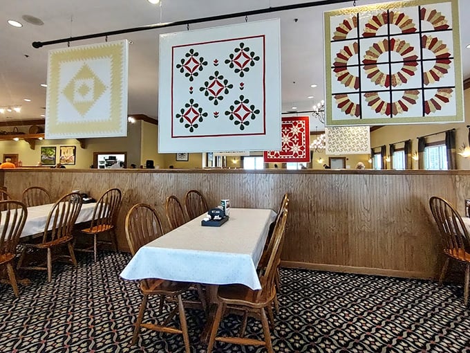 Suspended quilt designs transform ordinary walls into a gallery of Amish craftsmanship. These aren't just decorations; they're cultural touchstones hanging above your meatloaf.