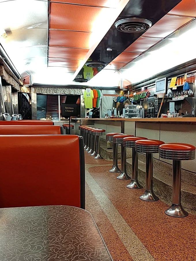The nighttime diner interior glows with promise. Those empty stools aren't just waiting for customers—they're waiting for stories to unfold.