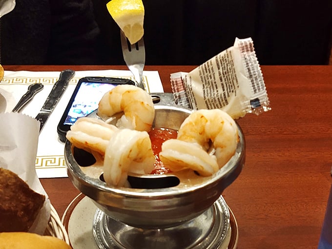 The legendary shrimp cocktail in all its glory—plump crustaceans perched on the edge of that spicy sauce like divers contemplating the perfect plunge.