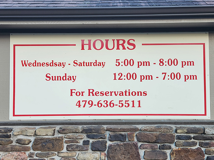The hours sign tells you everything you need to know – including that reservations aren't just suggested, they're practically required for this chicken mecca.