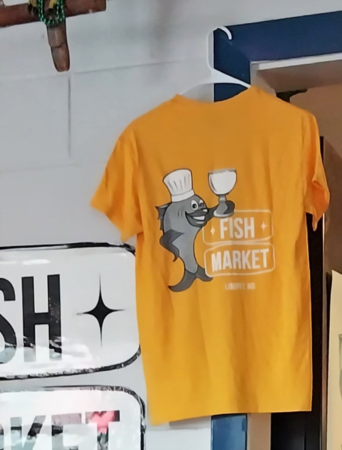 Even the merch tells a story – a cheerful cartoon fish in a chef's hat holding a wine glass says, "We take our seafood seriously, but not ourselves."