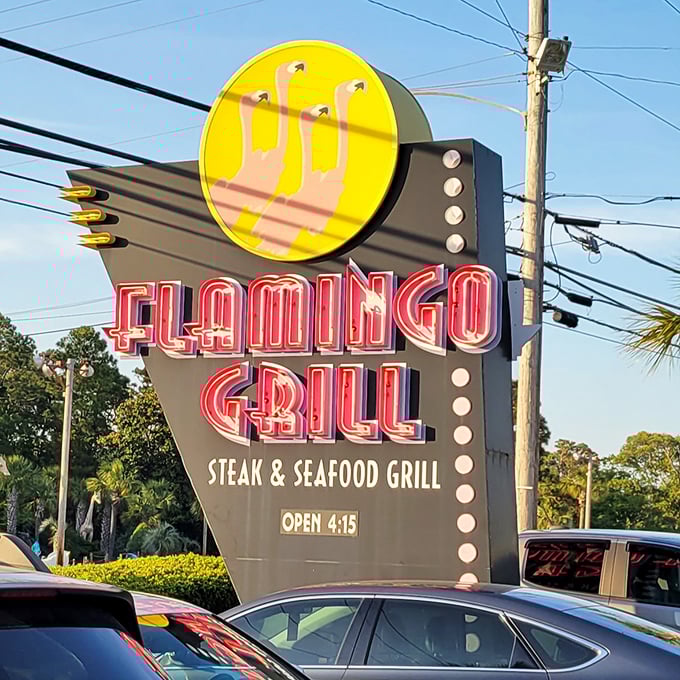 A sign that belongs in the Neon Hall of Fame, beckoning hungry travelers with the promise of steaks and seafood.