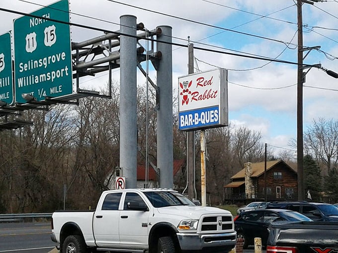 Road signs and the Red Rabbit logo—navigational tools guiding hungry travelers to burger paradise since the days of finned Cadillacs.