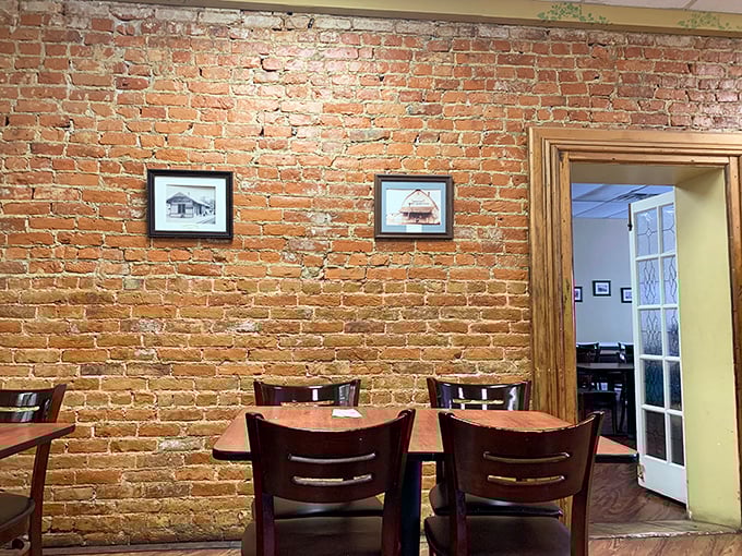 Simple tables against exposed brick—no designer needed when authenticity does the decorating. History you can touch while you eat.