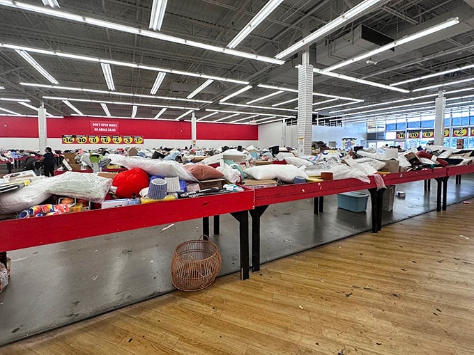 Tables displaying pillows and home goods stretch across the warehouse like a treasure map for the budget-conscious decorator.