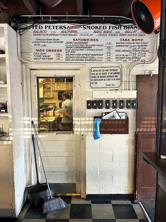 Behind this humble door lies the smoke-filled chamber where ordinary fish transcend to legendary status, like a fishy version of superhero origin stories.