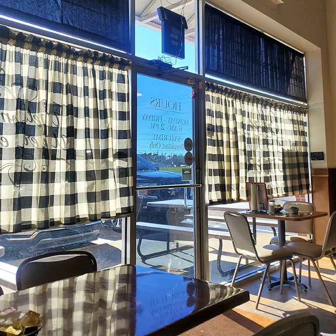 Black and white checkered curtains filter the morning light, creating the perfect backdrop for coffee conversations and biscuit deliberations.